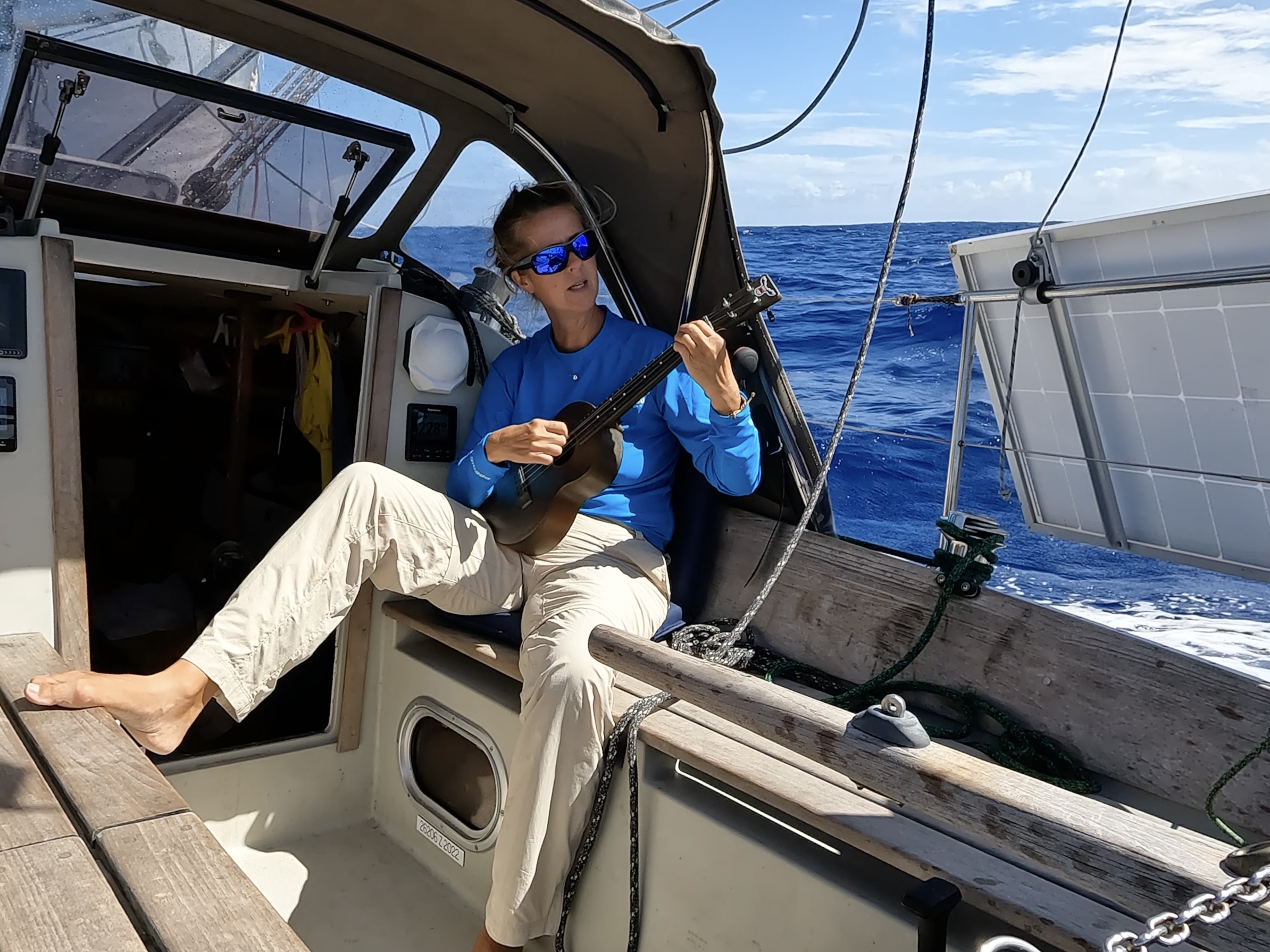 Playing the ukelele: singing a song about sailing around the world ...
